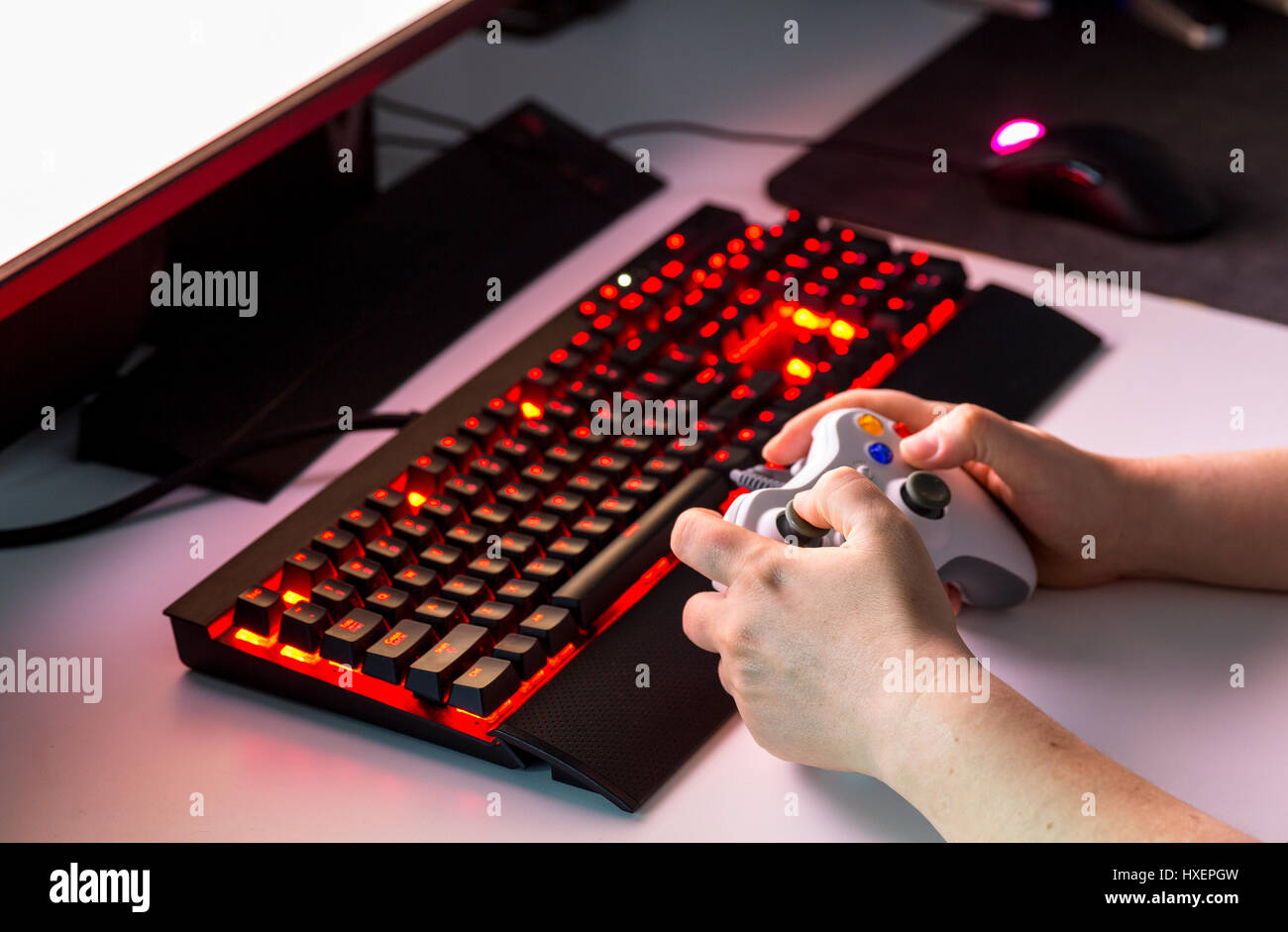 Hand holding game console controller playing game on the display Stock ...