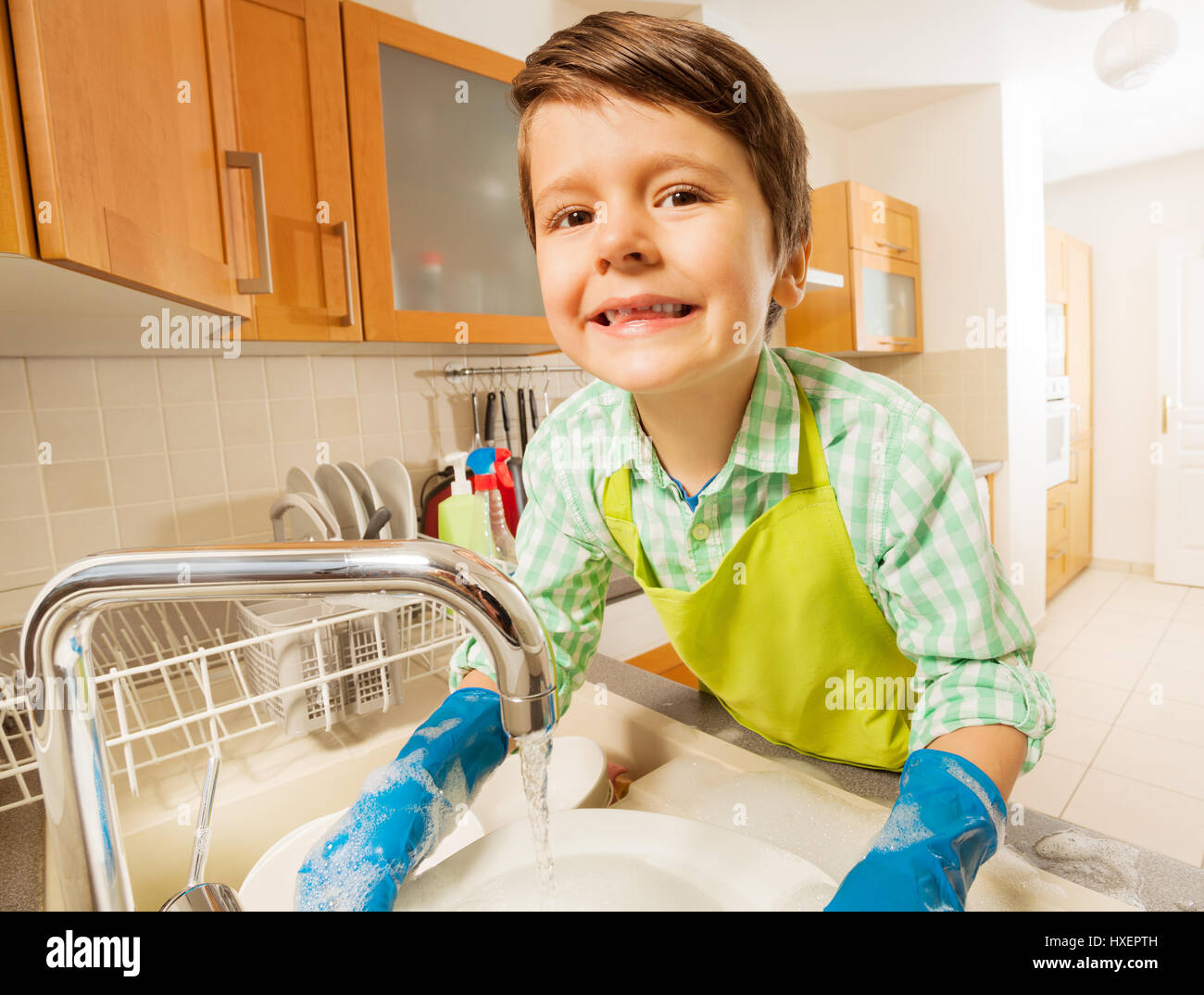 Boy washing dishes hi-res stock photography and images - Alamy