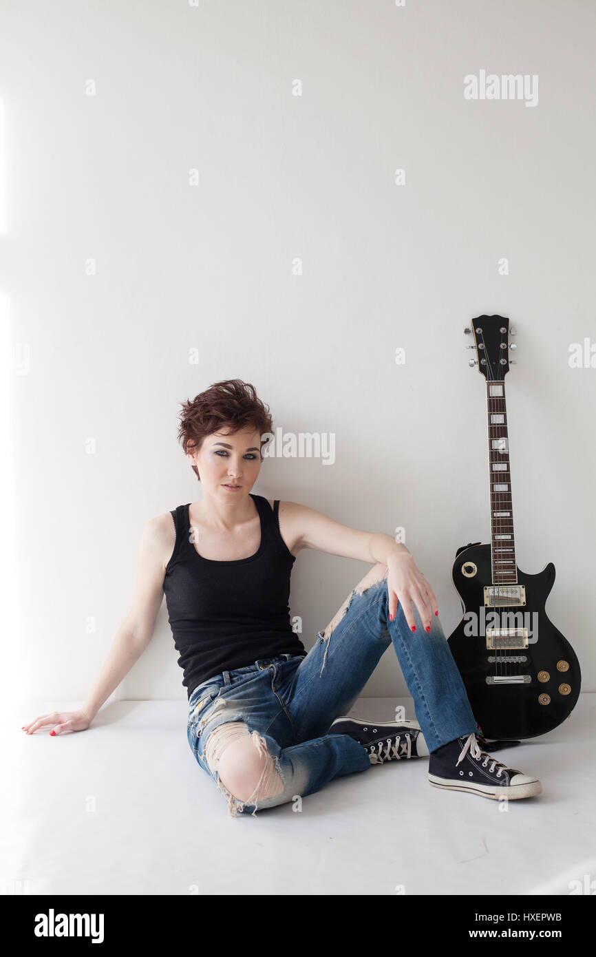 Playing guitar sitting on stool hi-res stock photography and images - Alamy