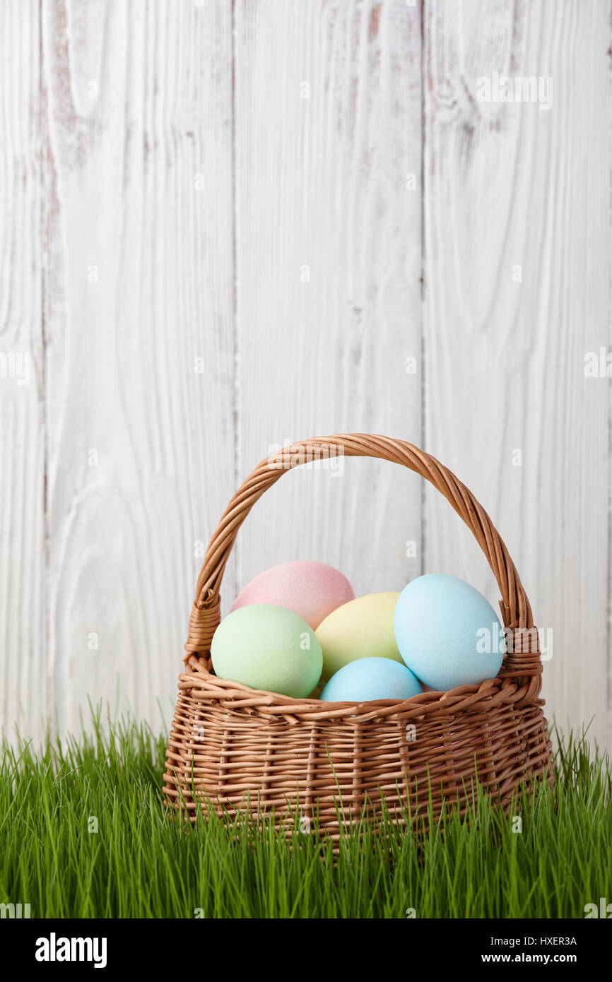 Easter eggs basket in grass meadow Stock Photo - Alamy