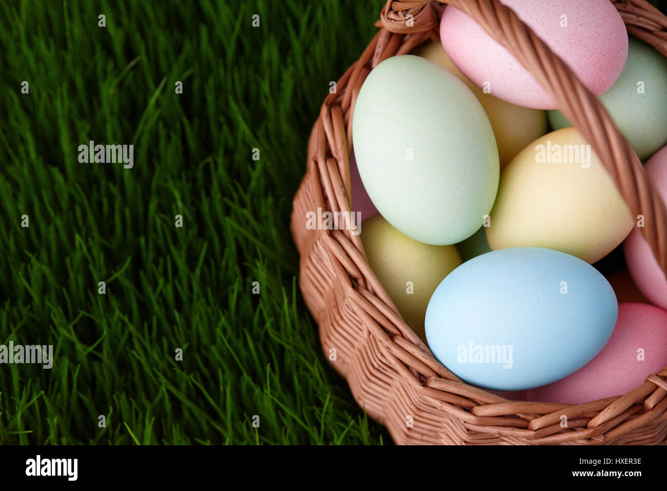 Easter eggs basket in grass meadow Stock Photo - Alamy