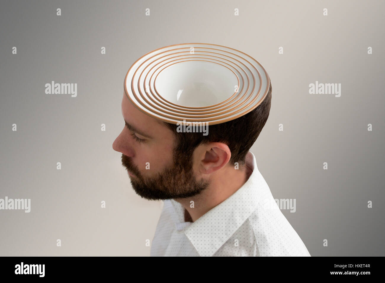Several ceramic bowls inside a man's head Stock Photo - Alamy