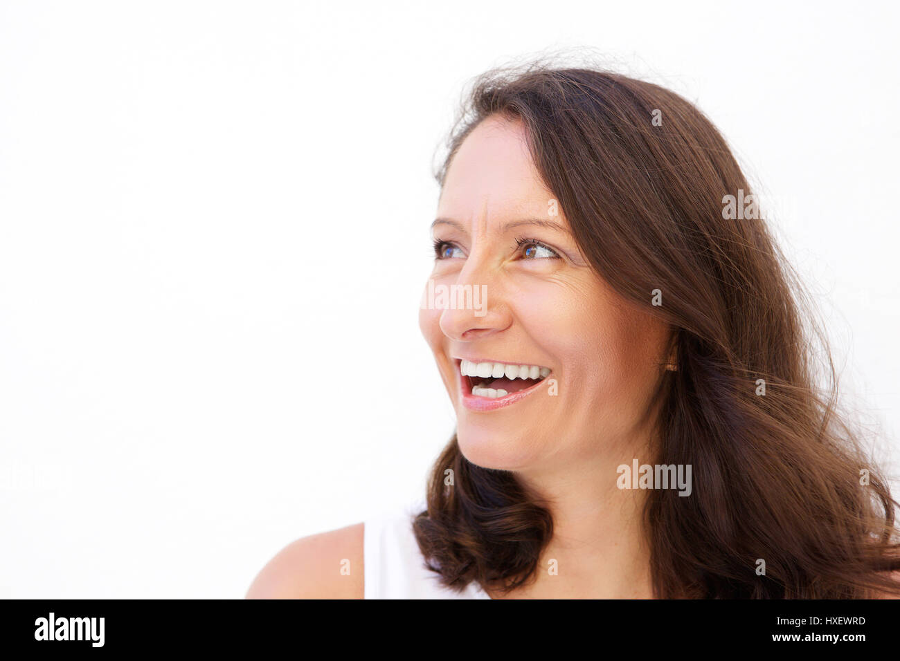 Close up woman face laughing against white background Stock Photo - Alamy