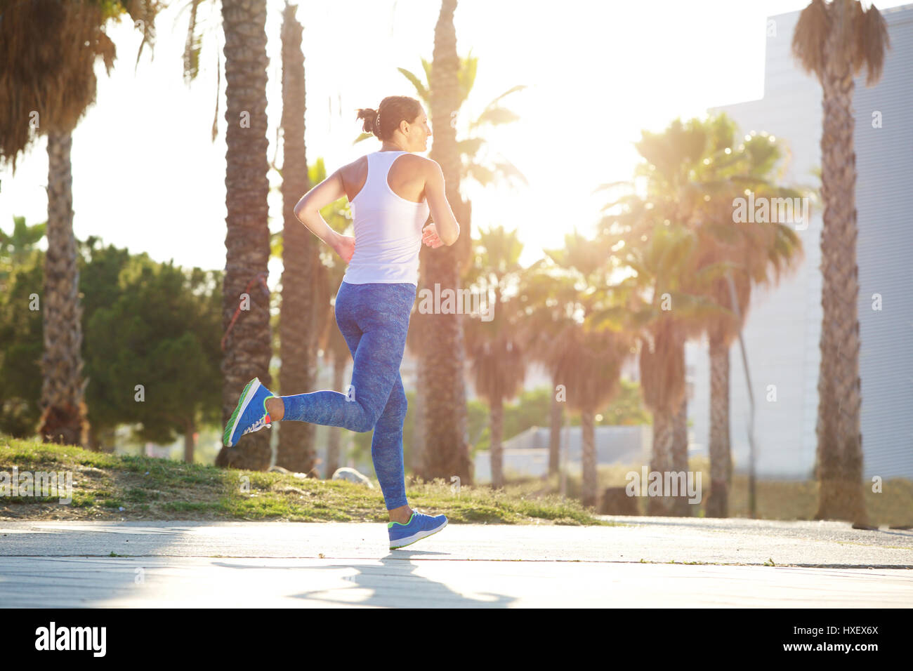 Full length side portrait of a female runner outside Stock Photo - Alamy