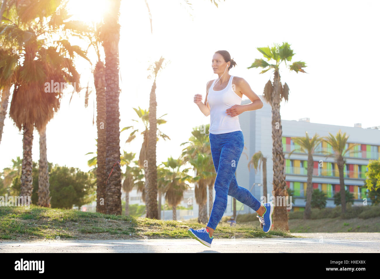 Full body portrait of a fit woman exercise running outdoors Stock Photo ...