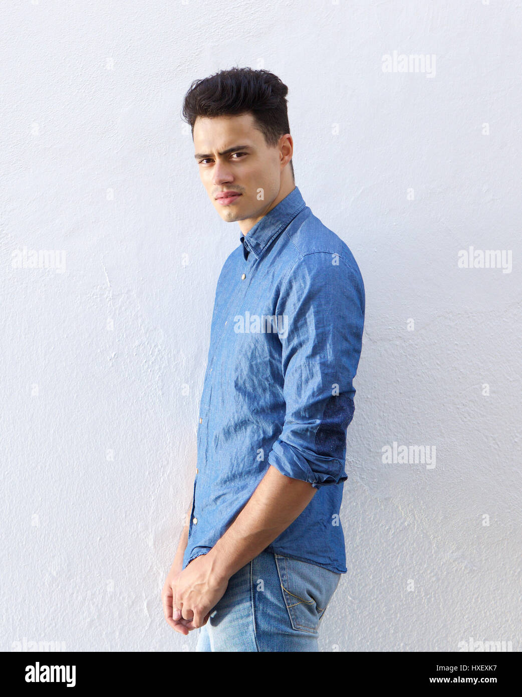 Portrait of a handsome young man in denim blue shirt staring Stock ...