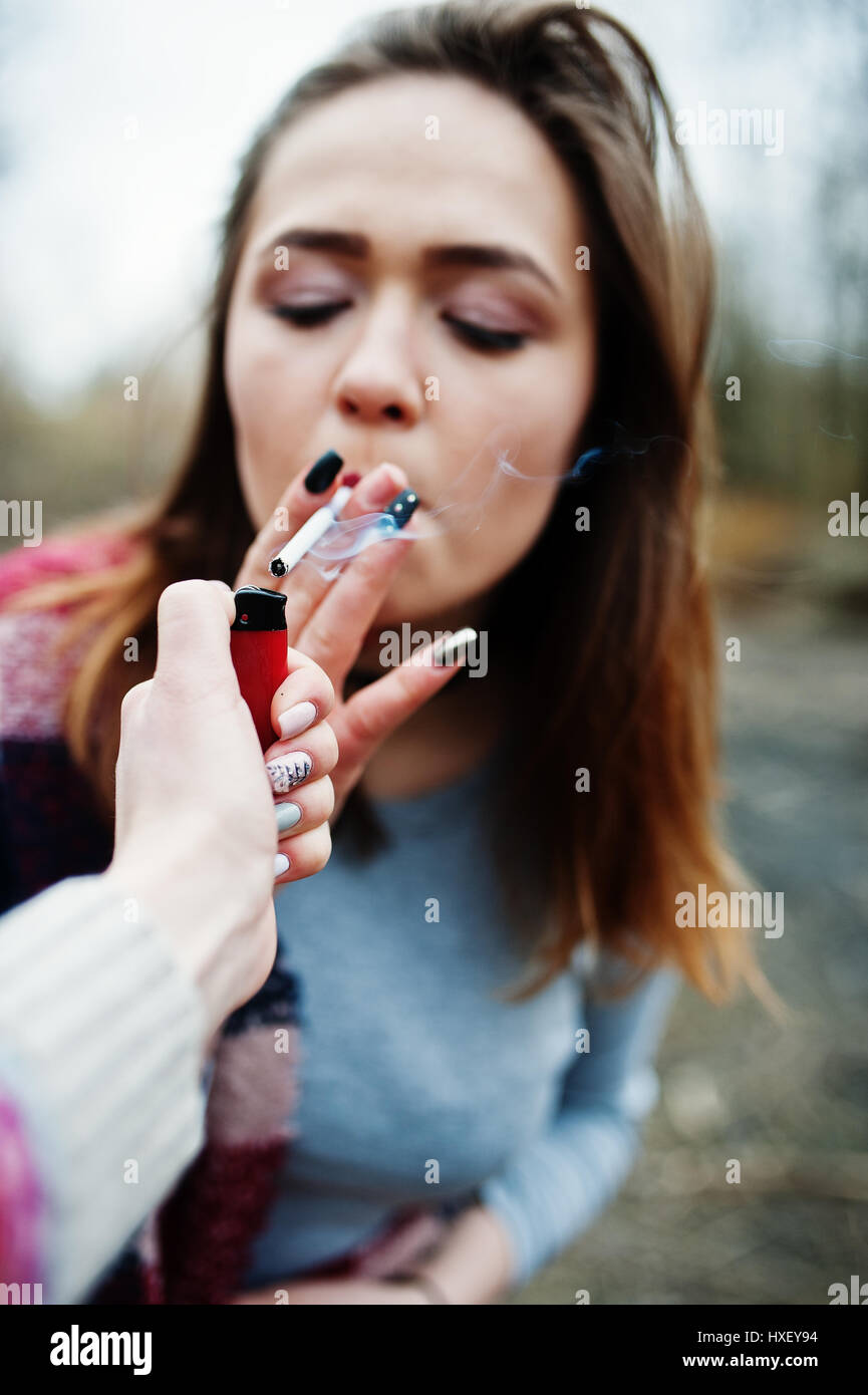Woman lighting friends cigarette hi-res stock photography and images ...