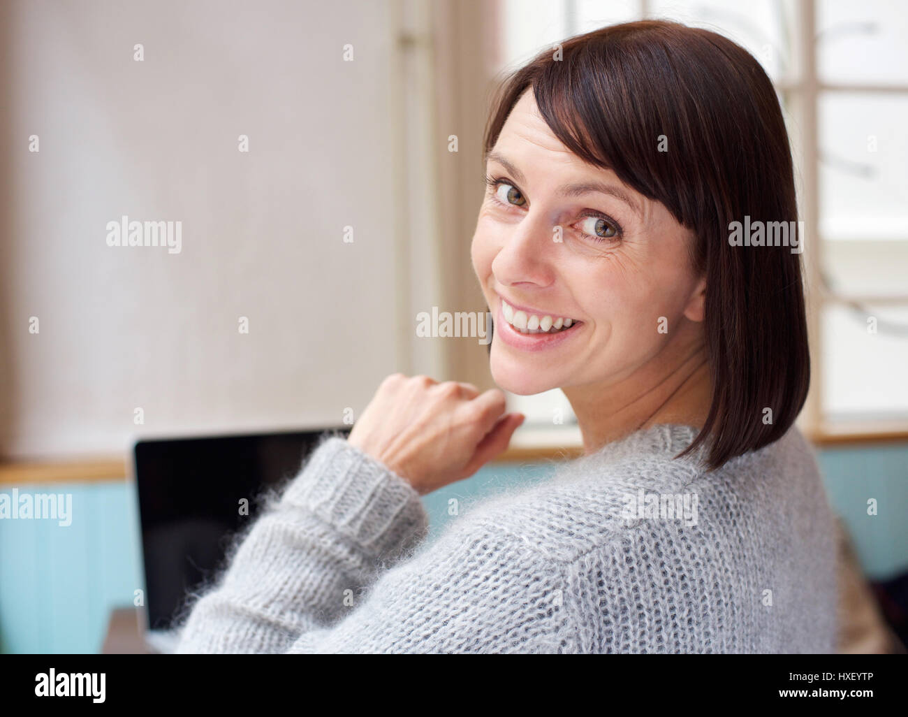 Behind portrait woman smiling at home with laptop Stock Photo - Alamy
