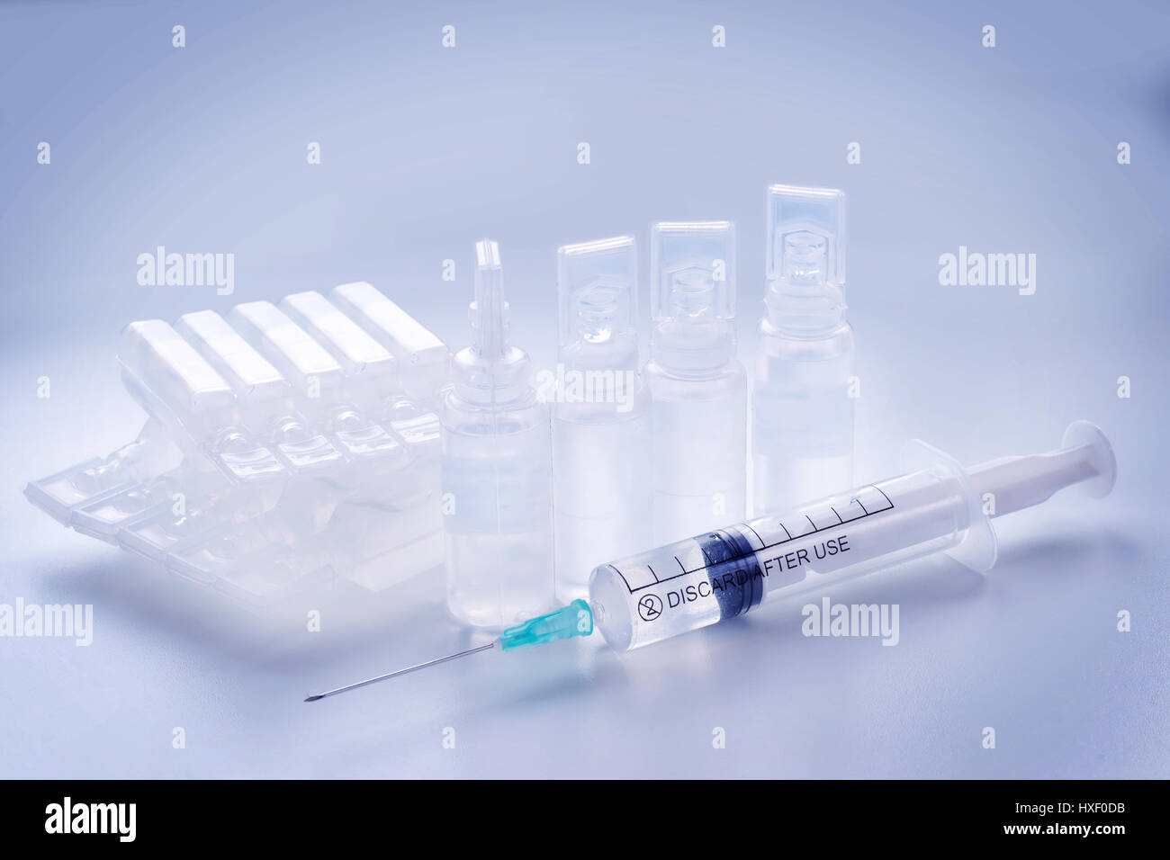 Group of plastic ampules and syringe. Health, treatment and modern ...