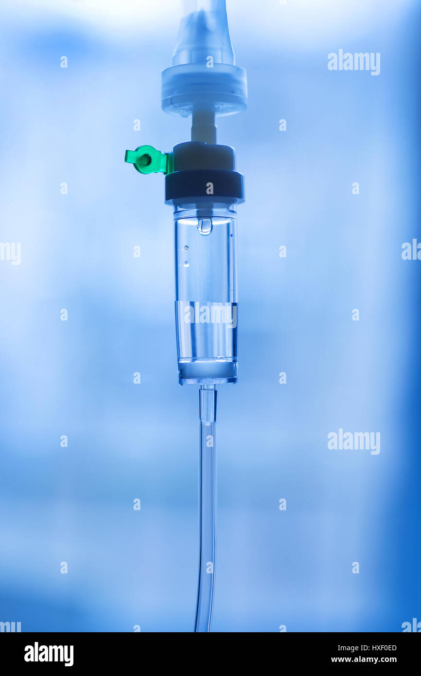 Part of disposable infusion set close up. On abstract blue background ...