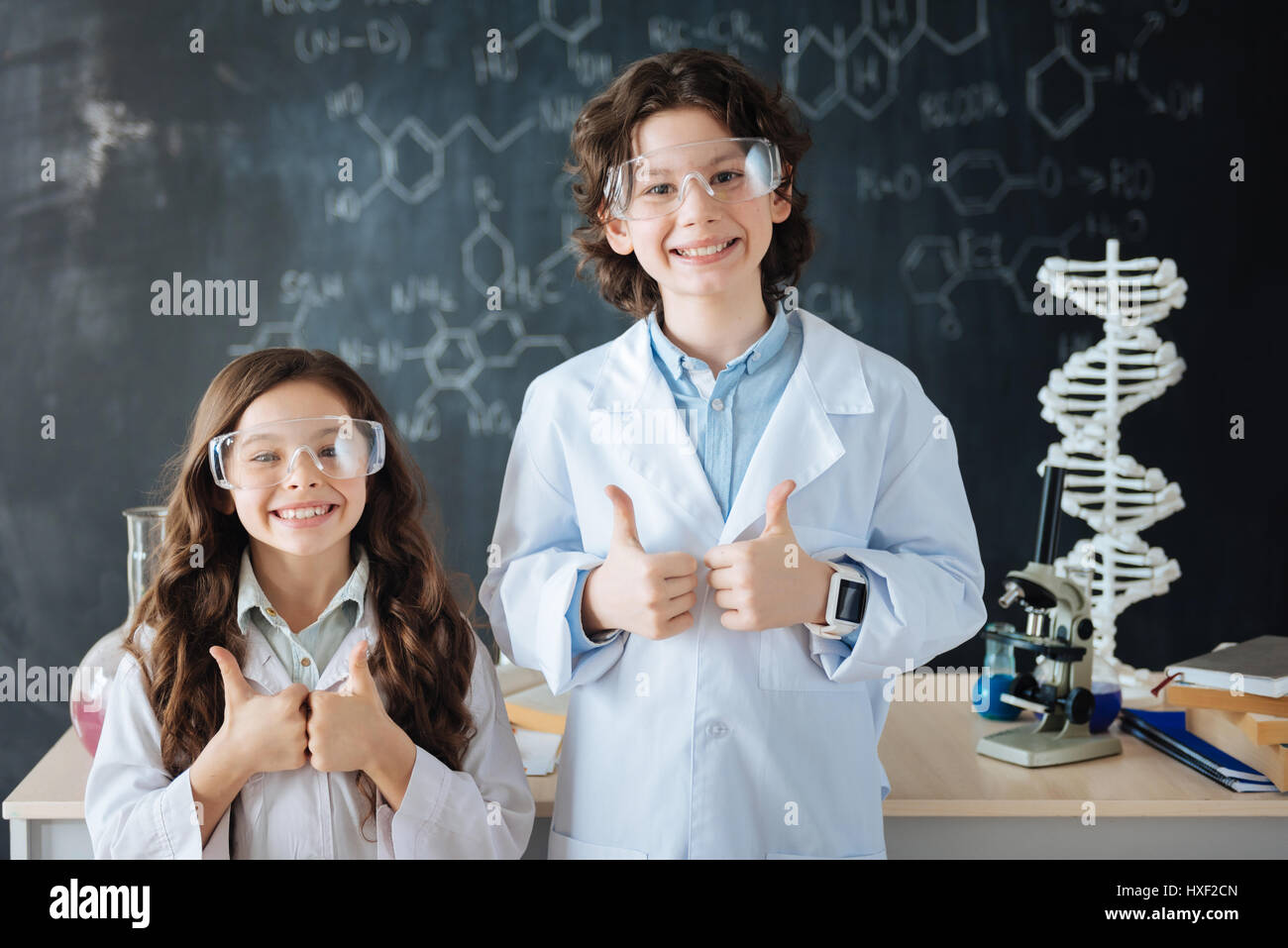 Cheerful little researchers enjoying science class at school Stock ...