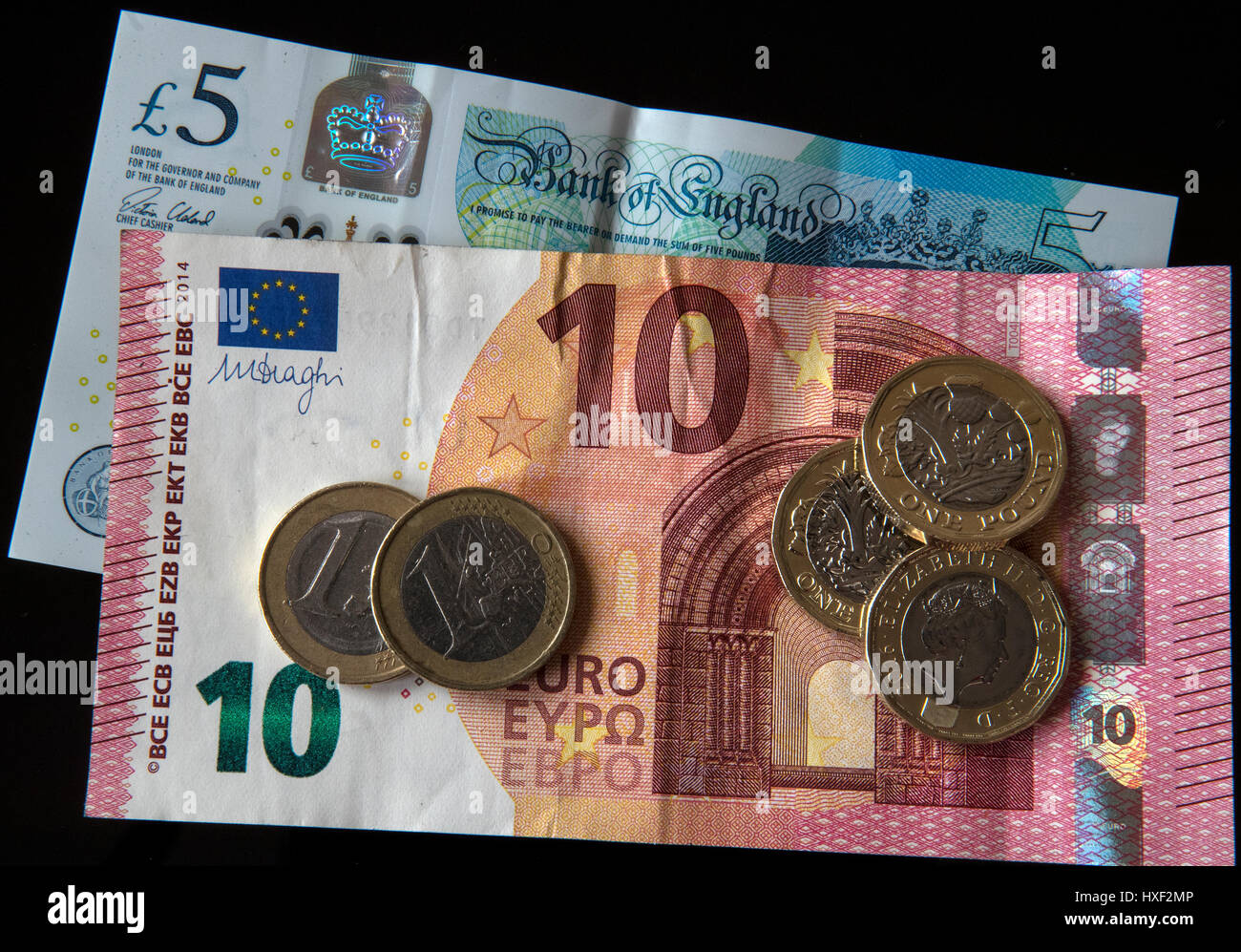 New 12-sided £1 and 1 Euro coins on a new £5 note and 10 Euro note in ...