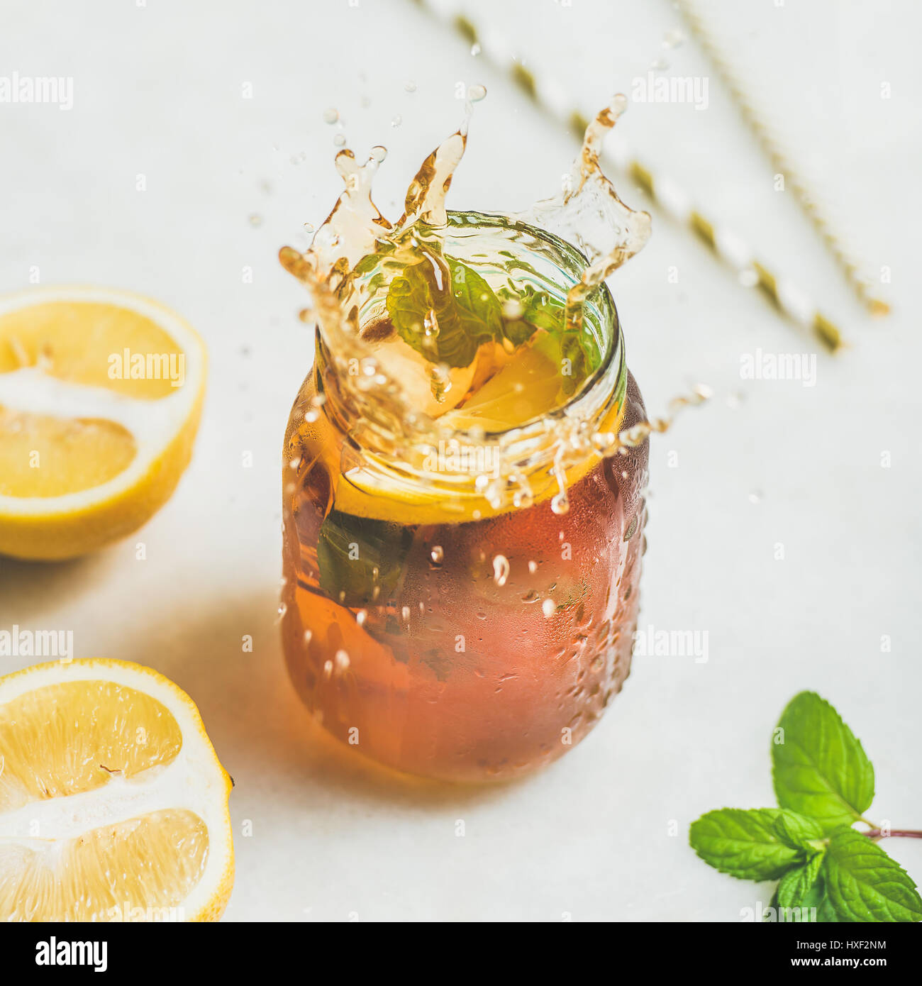 Summer cold Iced tea with lemon and herbs, square crop Stock Photo - Alamy