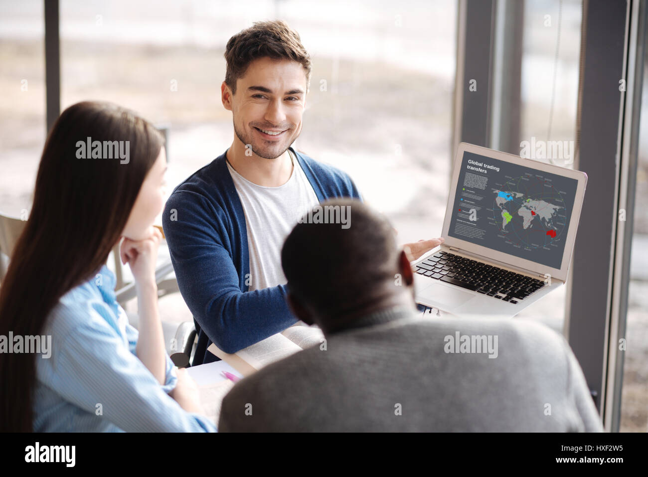 Young guy presenting information from laptop Stock Photo - Alamy
