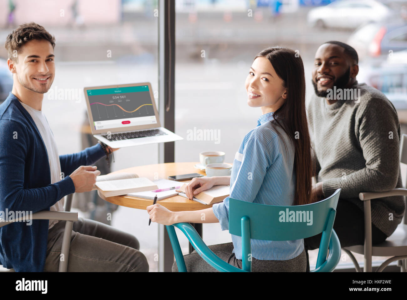 Young guy presenting information from laptop Stock Photo - Alamy