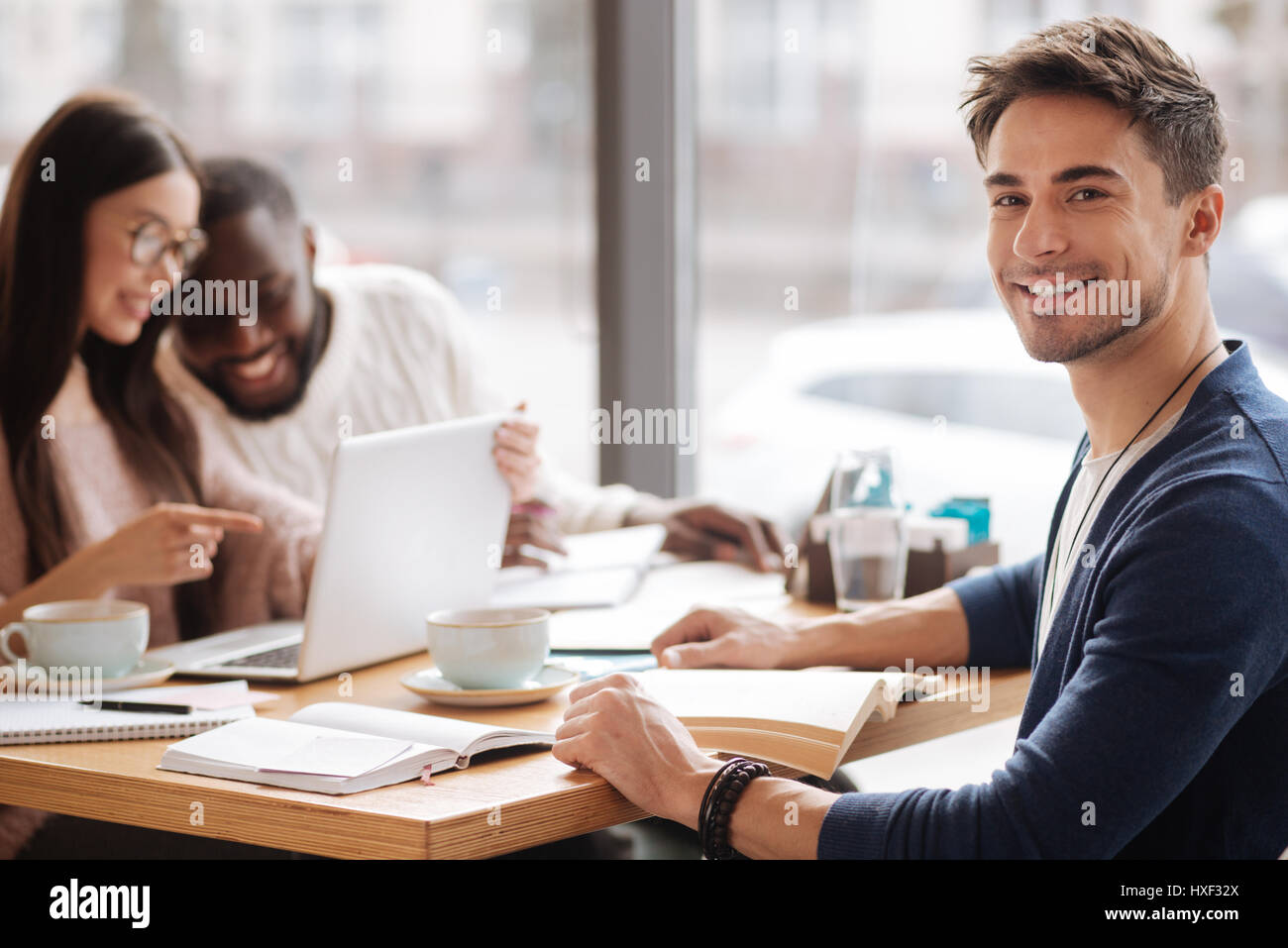 Young man sitting in the cafe Stock Photo - Alamy