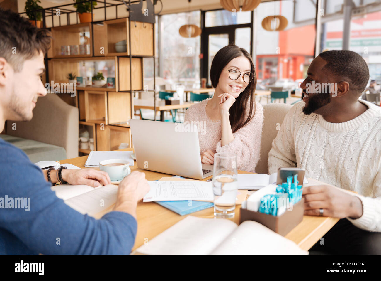 Group of students having conversation at cafe Stock Photo - Alamy