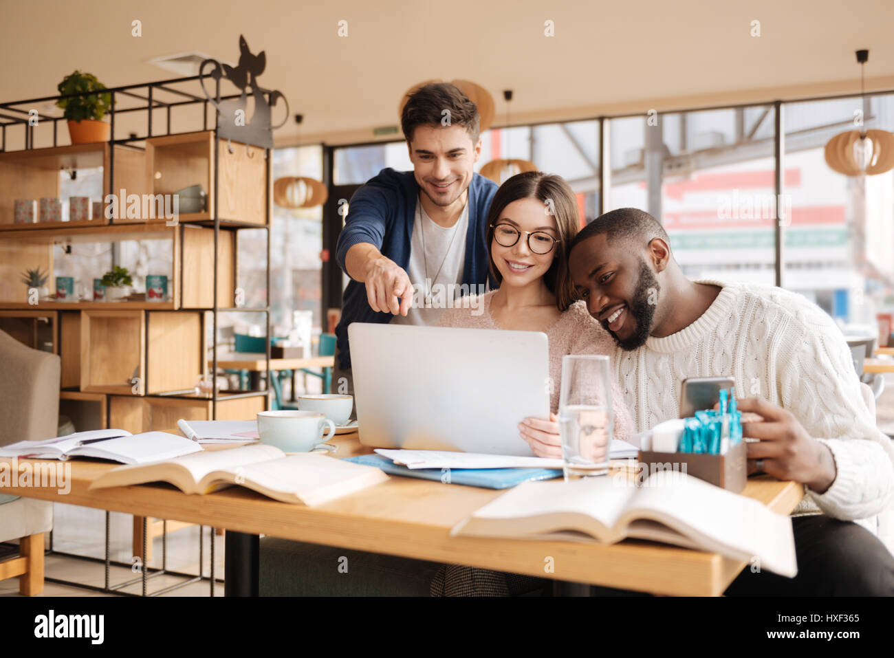 Positive students working on the project together Stock Photo - Alamy