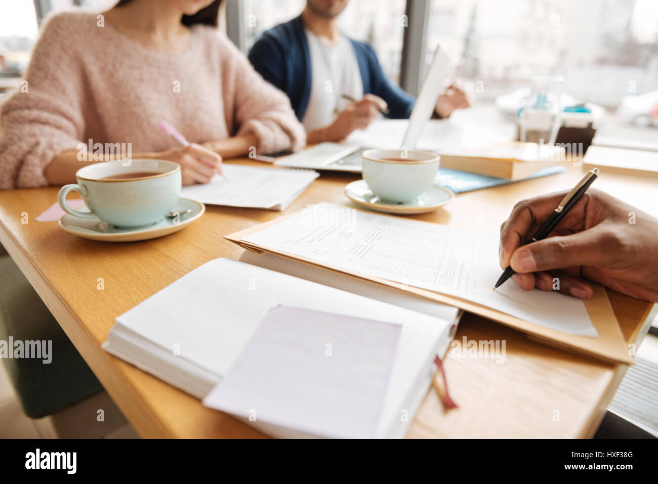 Close up of students taking notes Stock Photo - Alamy