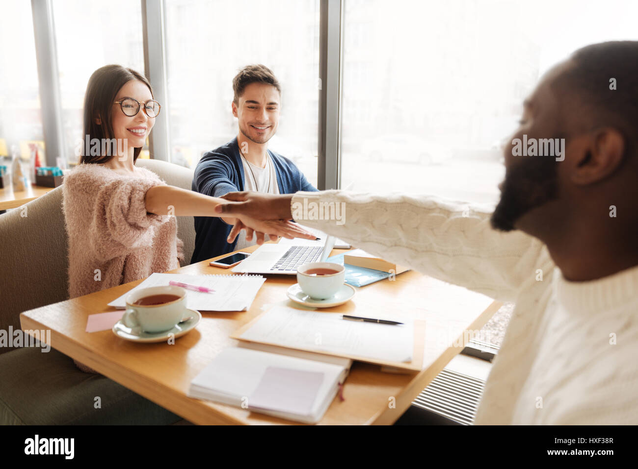 Positive smiling students studying together Stock Photo - Alamy