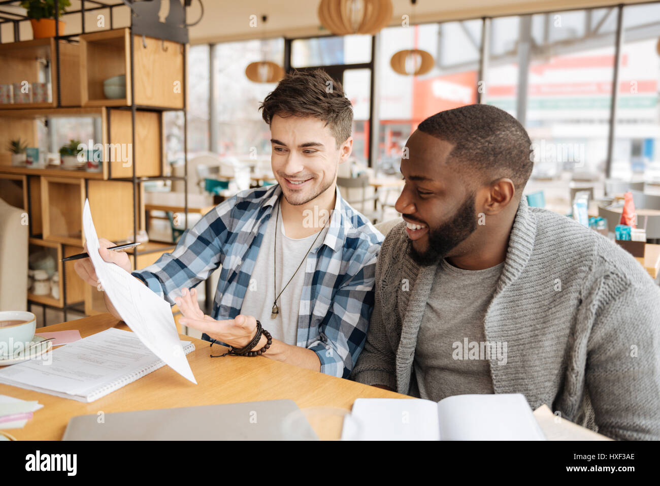 Two students checking their notes Stock Photo - Alamy