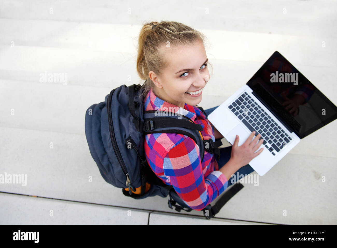 Portrait from above smiling female student sitting with laptop Stock ...