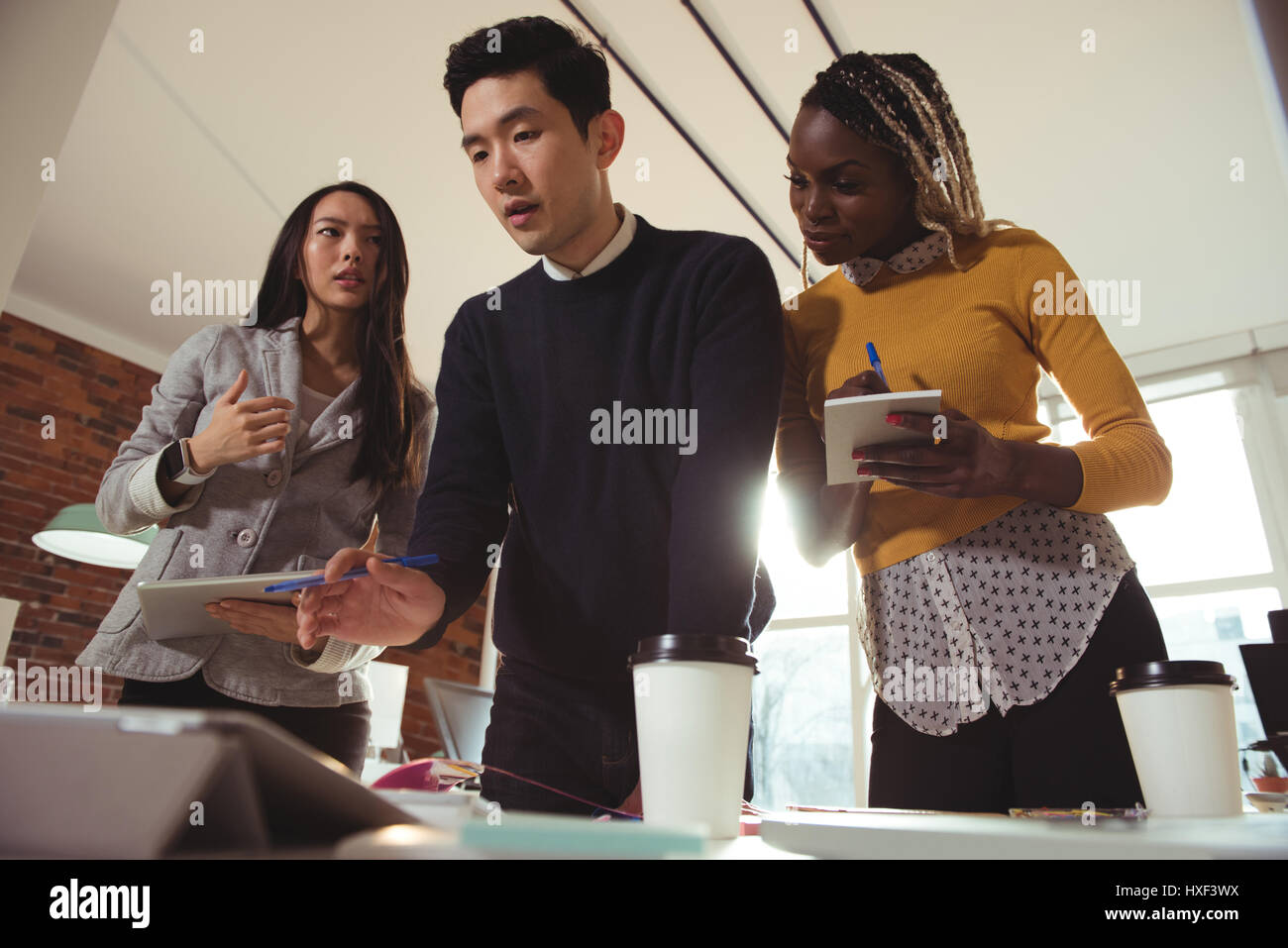 Group of executives working together at desk in office Stock Photo - Alamy