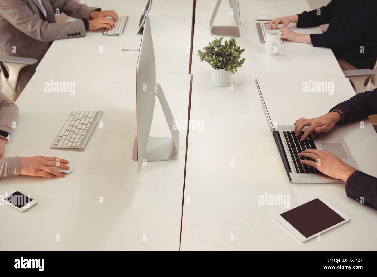 Group of executives working at desk in office Stock Photo - Alamy