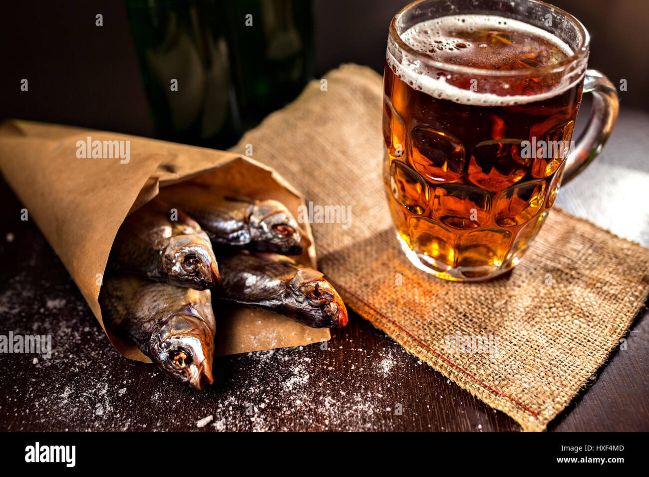 dried fish and vintage glass of beer on a black background Stock Photo ...