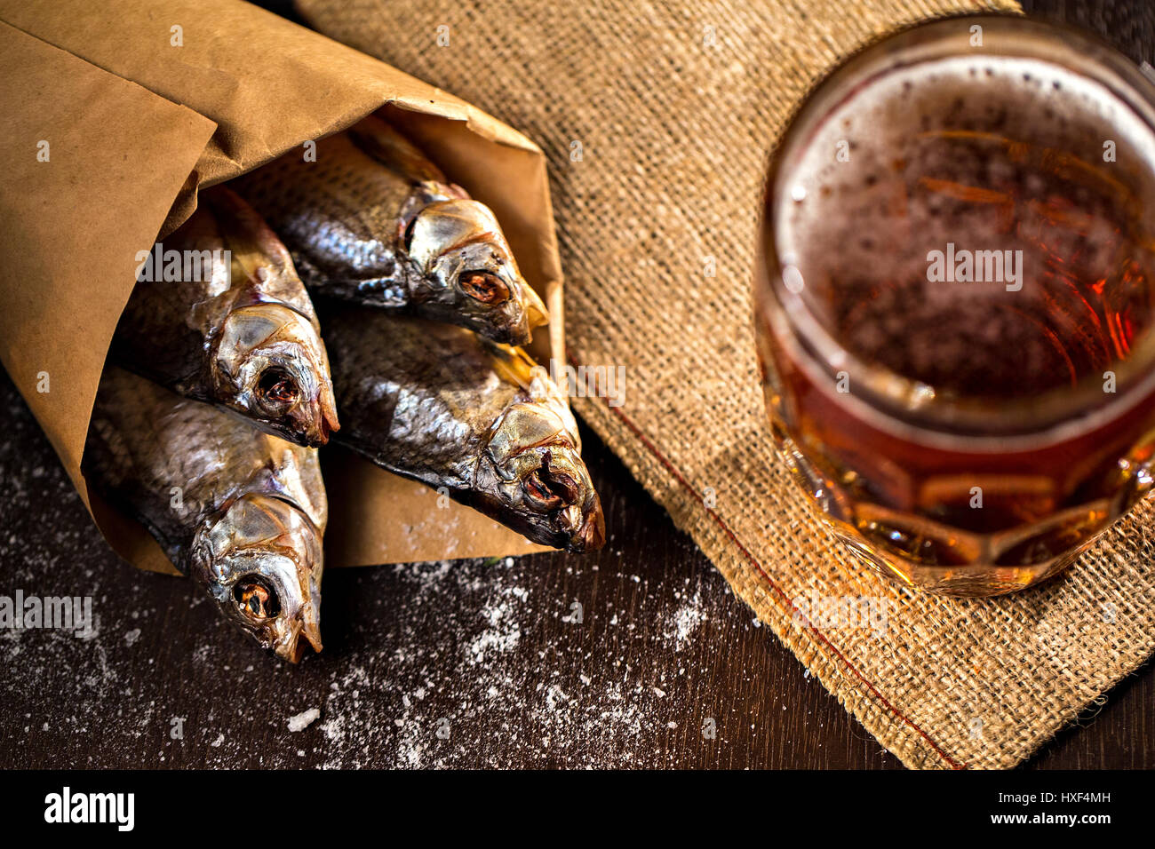 dried fish and vintage glass of beer on a black background Stock Photo ...