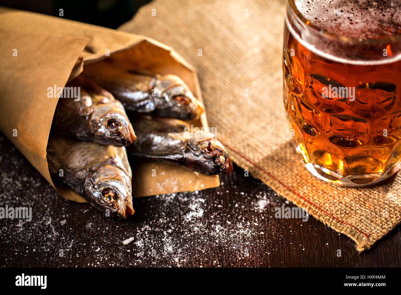 dried fish and vintage glass of beer on a black background Stock Photo ...
