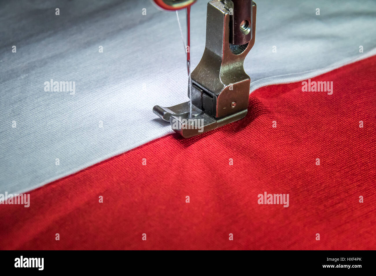 Professional sewing machine with white and red fabric Stock Photo - Alamy