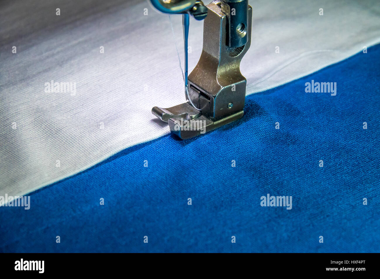 Professional sewing machine with white and blue fabric Stock Photo - Alamy