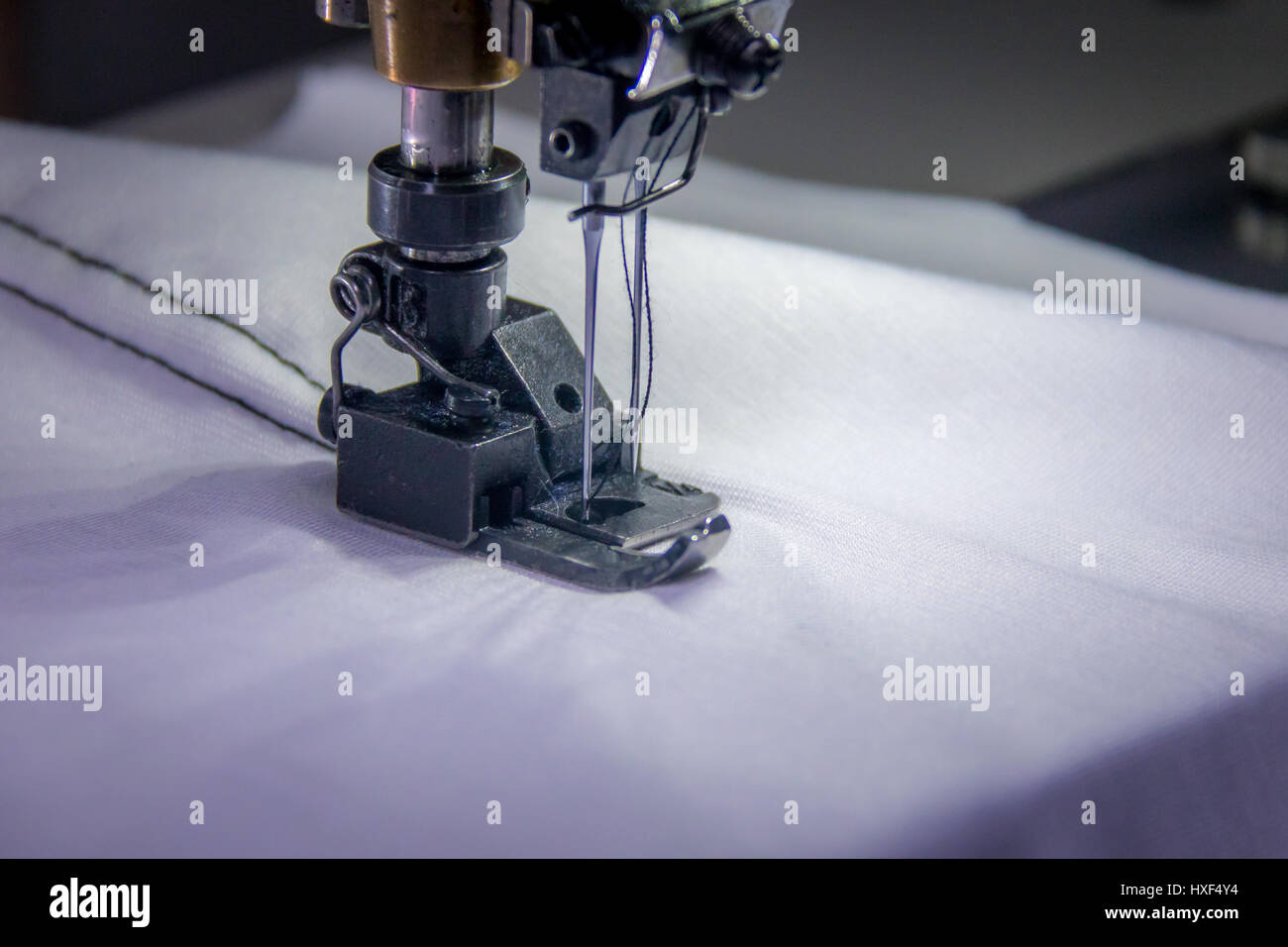 Professional dual needle sewing machine with white fabric Stock Photo ...