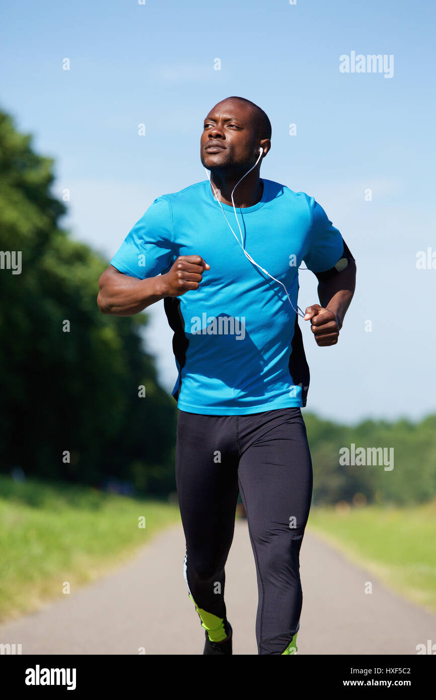 Young sporty african american man running outside Stock Photo - Alamy