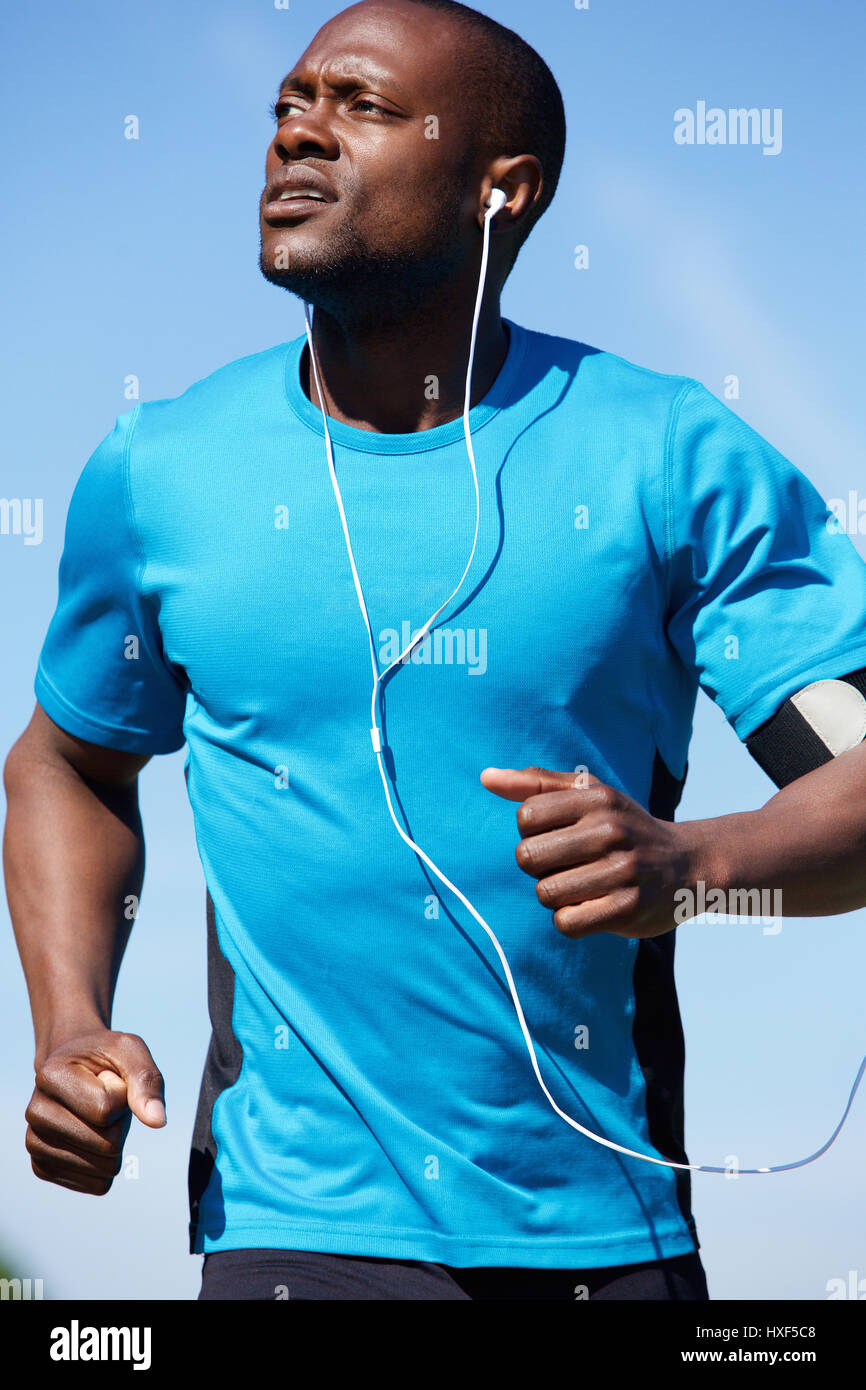 Portrait of a healthy young man running outdoors Stock Photo - Alamy