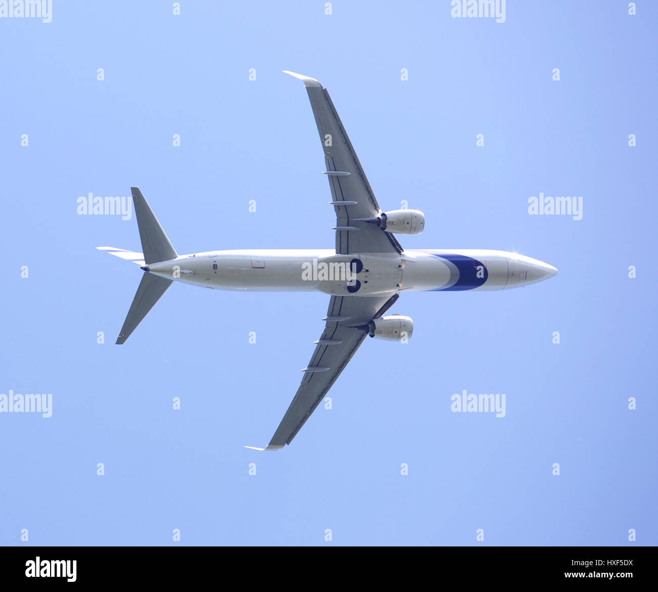 Large passenger plane flying high in the clear sky Stock Photo - Alamy