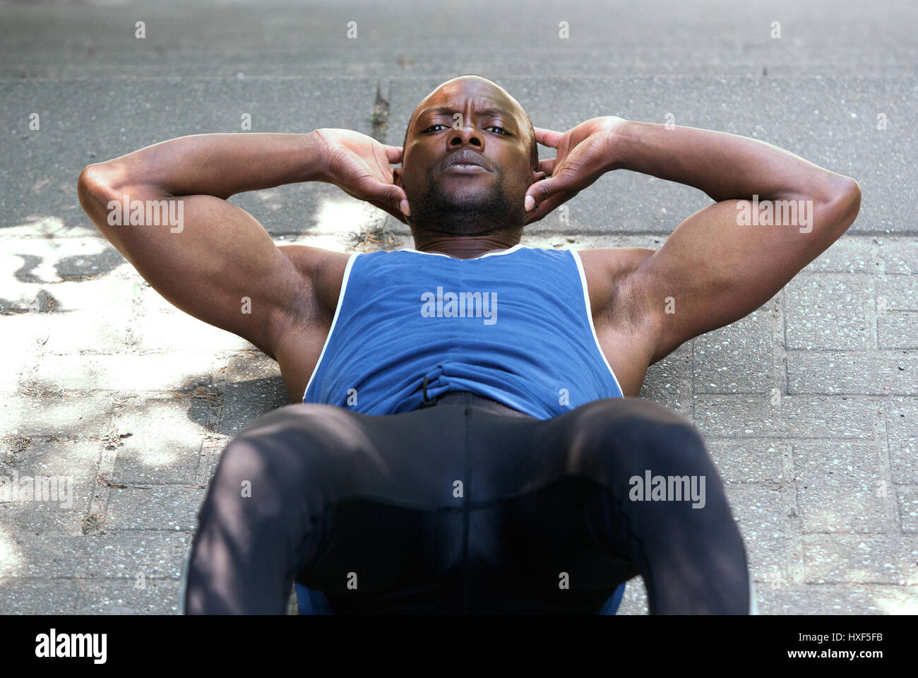 Sports man working on stomach crunch exercises Stock Photo - Alamy