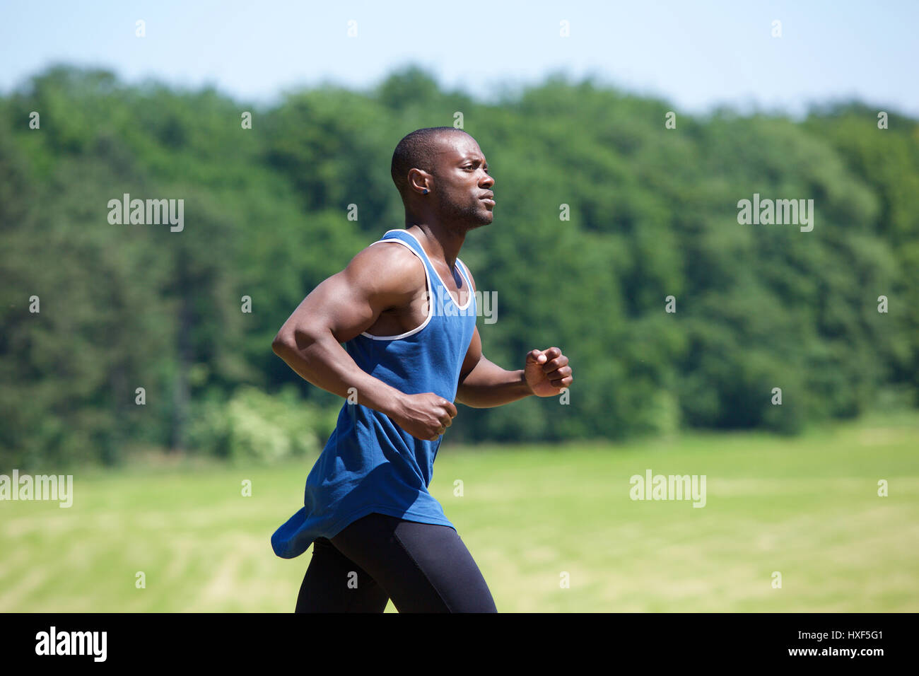 Side view portrait of a fit exercising man running outside Stock Photo ...