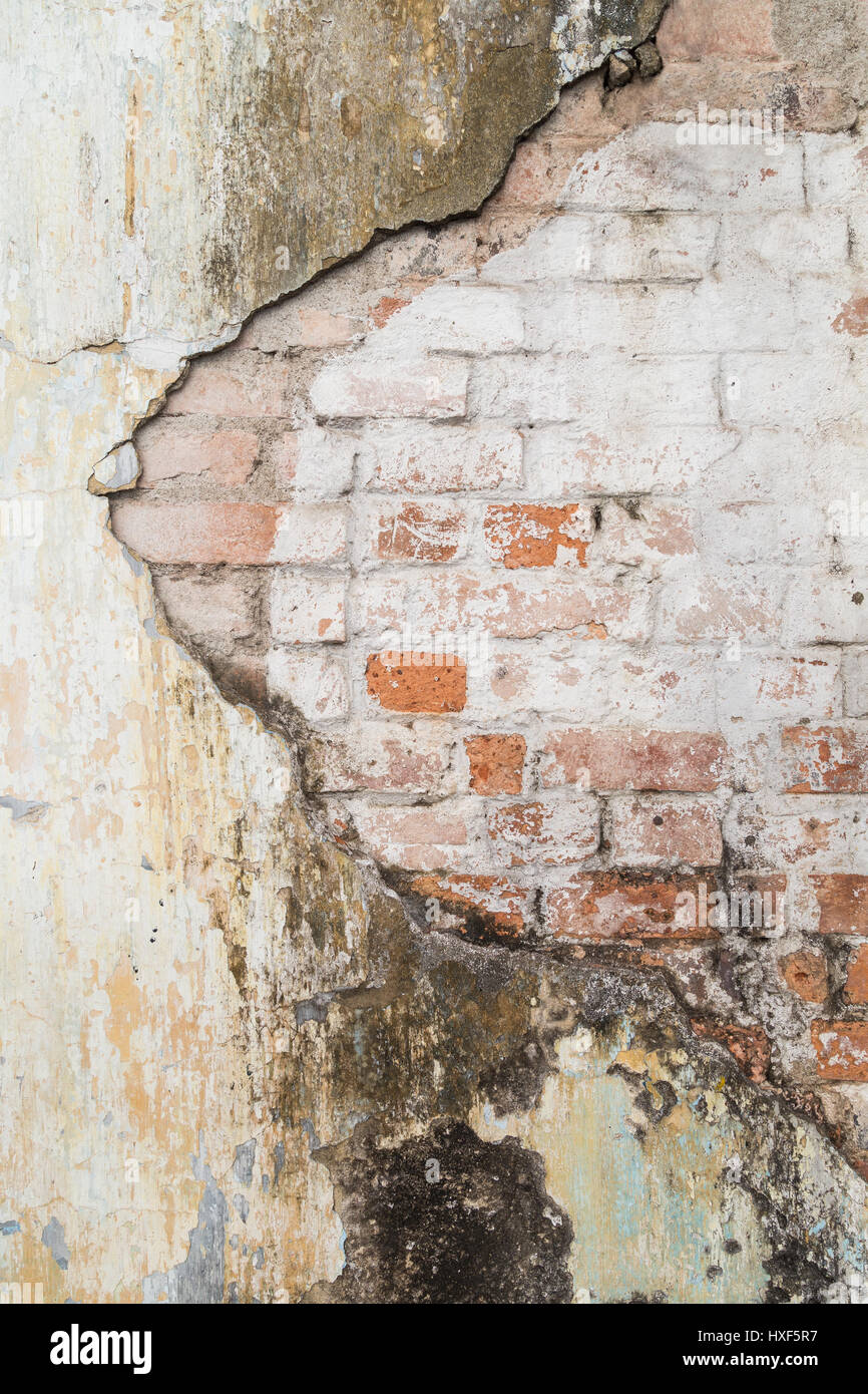 Broken old and dirty plastered wall revealing old brick wall Stock ...