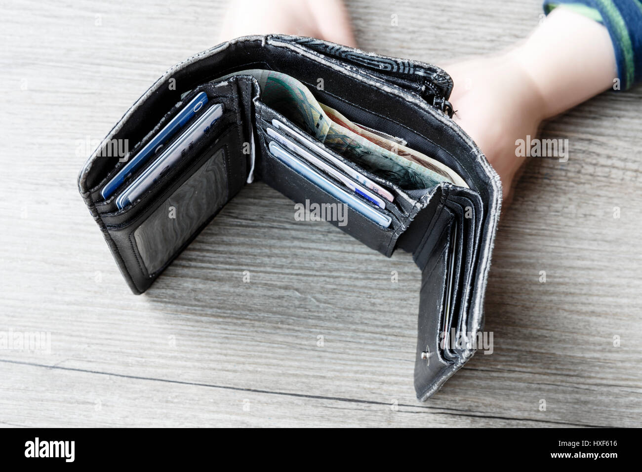 open black woman wallet with money and id cards on the wooden table ...