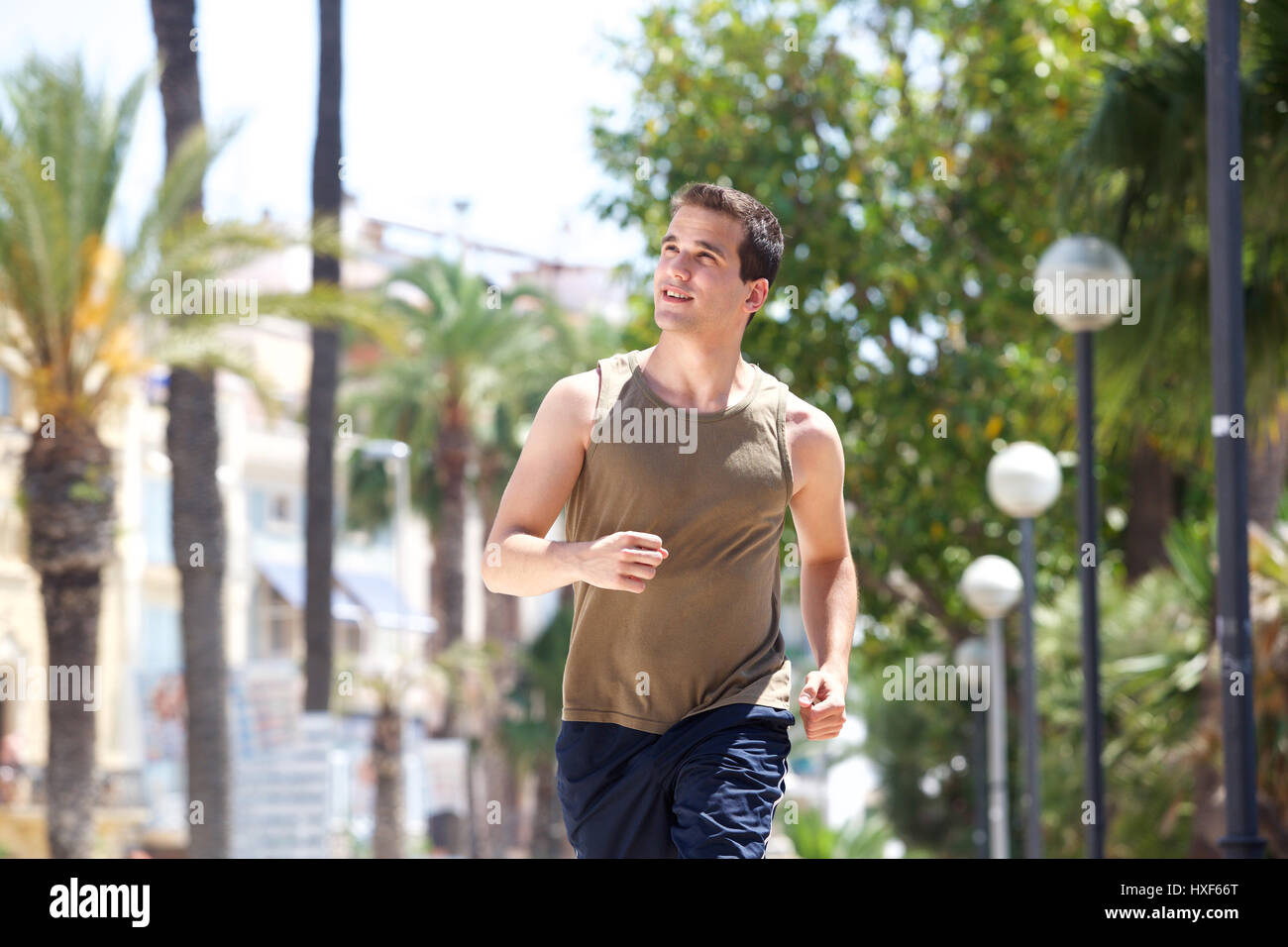 Portrait of a man running outside in summer Stock Photo - Alamy