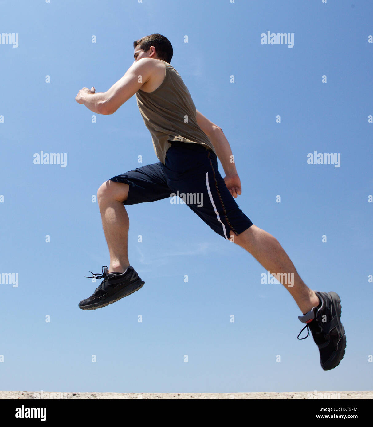 Active man jumping in the air outside Stock Photo - Alamy