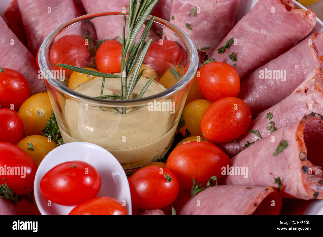 Cold Cuts Plate with tomatoes and a dip Stock Photo - Alamy
