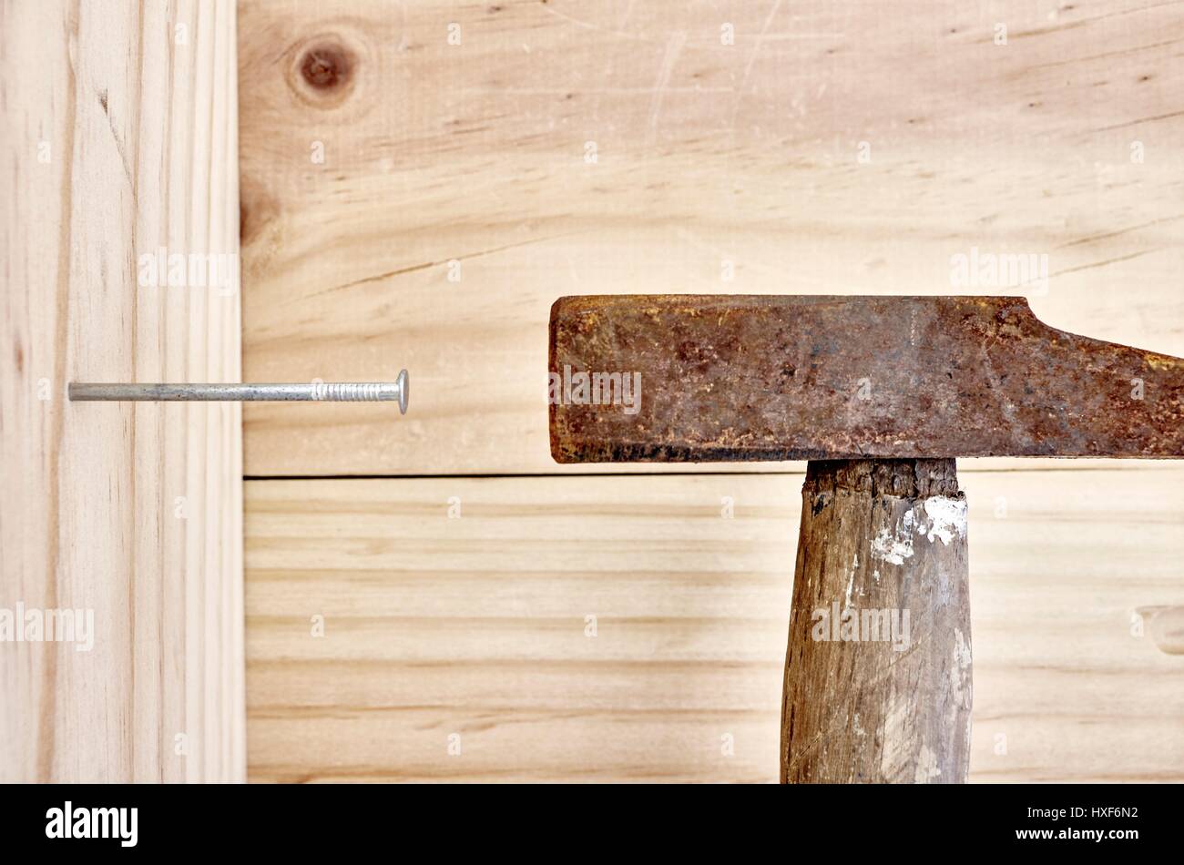 A studio photo of nailing into wood Stock Photo - Alamy