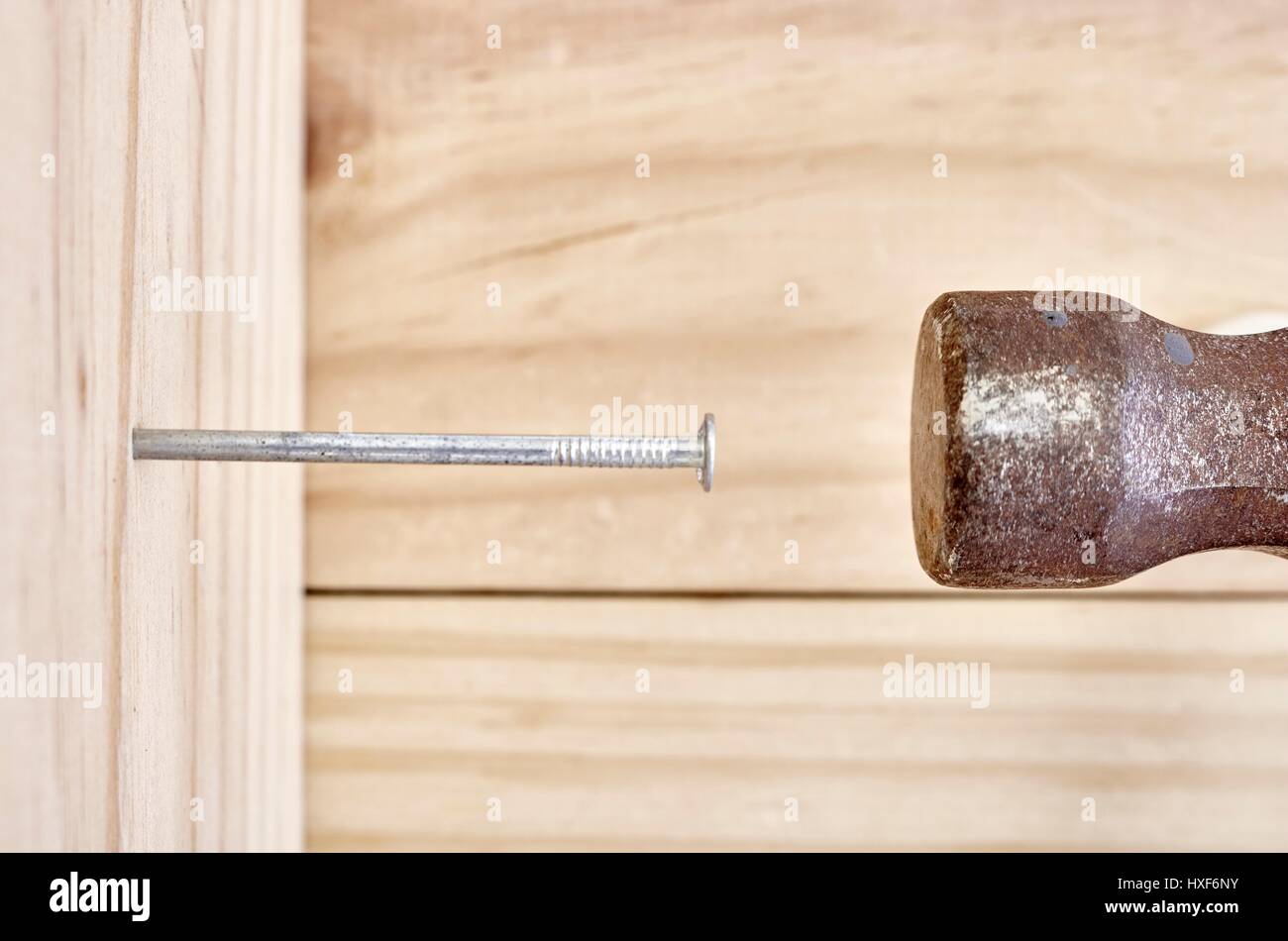 A studio photo of nailing into wood Stock Photo - Alamy
