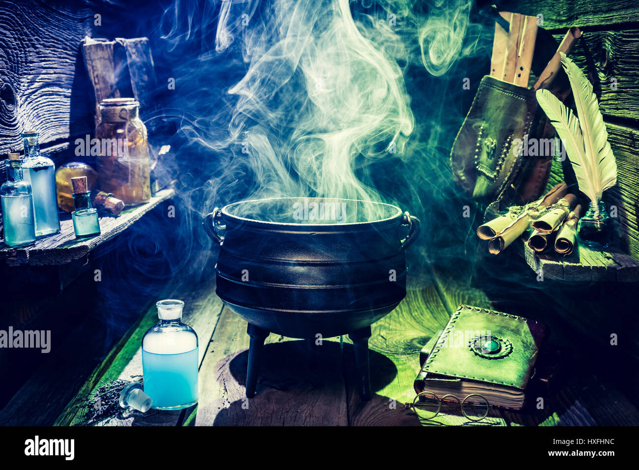 Magical witch pot with scrolls, books and blue potions for Halloween ...