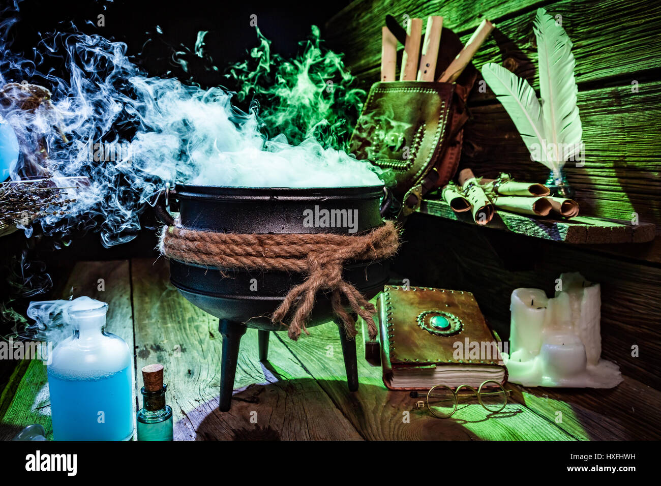 Mysterious witch pot with books and potions for Halloween Stock Photo ...