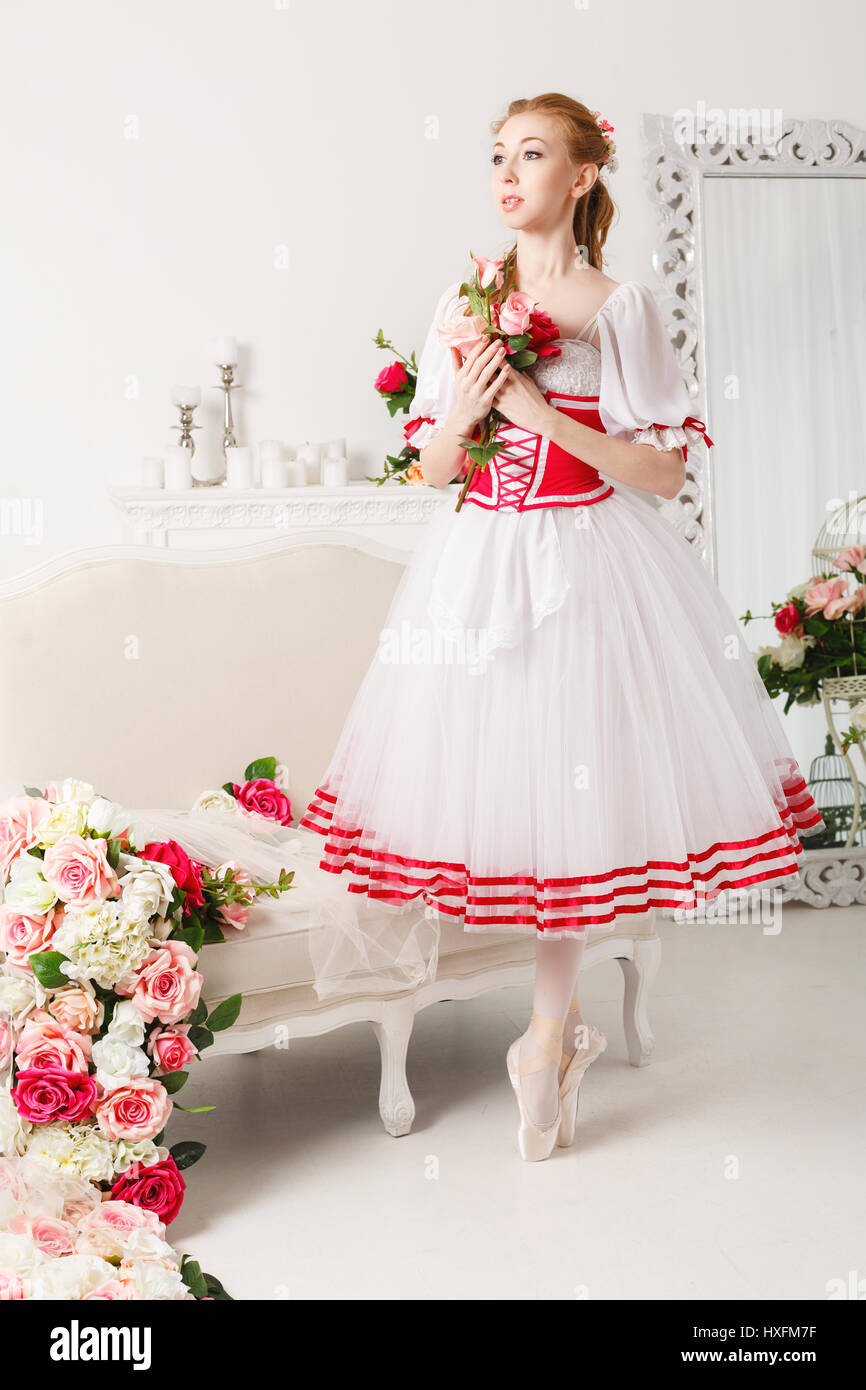 Pretty Ballerina In Stage Costume Holding A Bouquet Of Spring Flowers