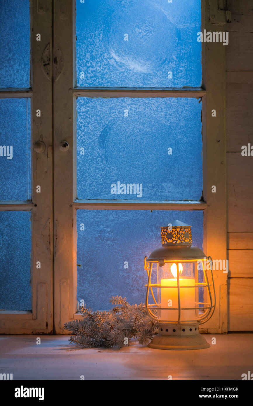 Frosted window at night with burning candle for Christmas Stock Photo ...